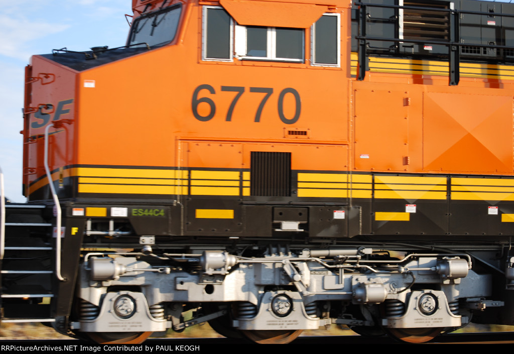 A 14 Day Old ES44C4 BNSF 6770 side shot as she heads west as a #2 unit behind BNSF 6719 the Leader.